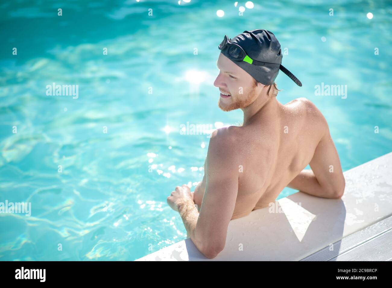 Male swimmer standing resting in water in pool Stock Photo - Alamy