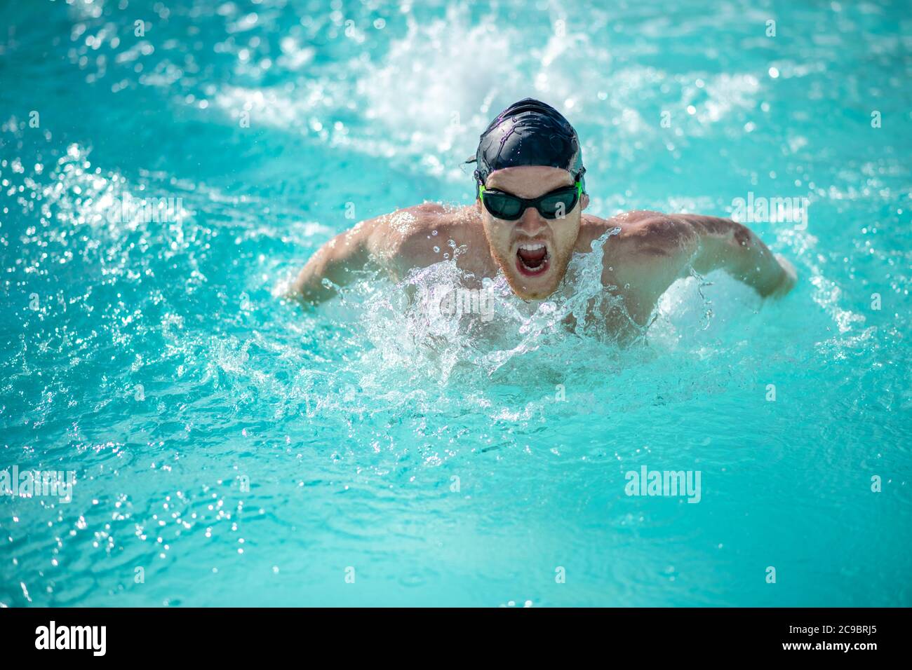 Male swimmer with open mouth arms underwater Stock Photo - Alamy