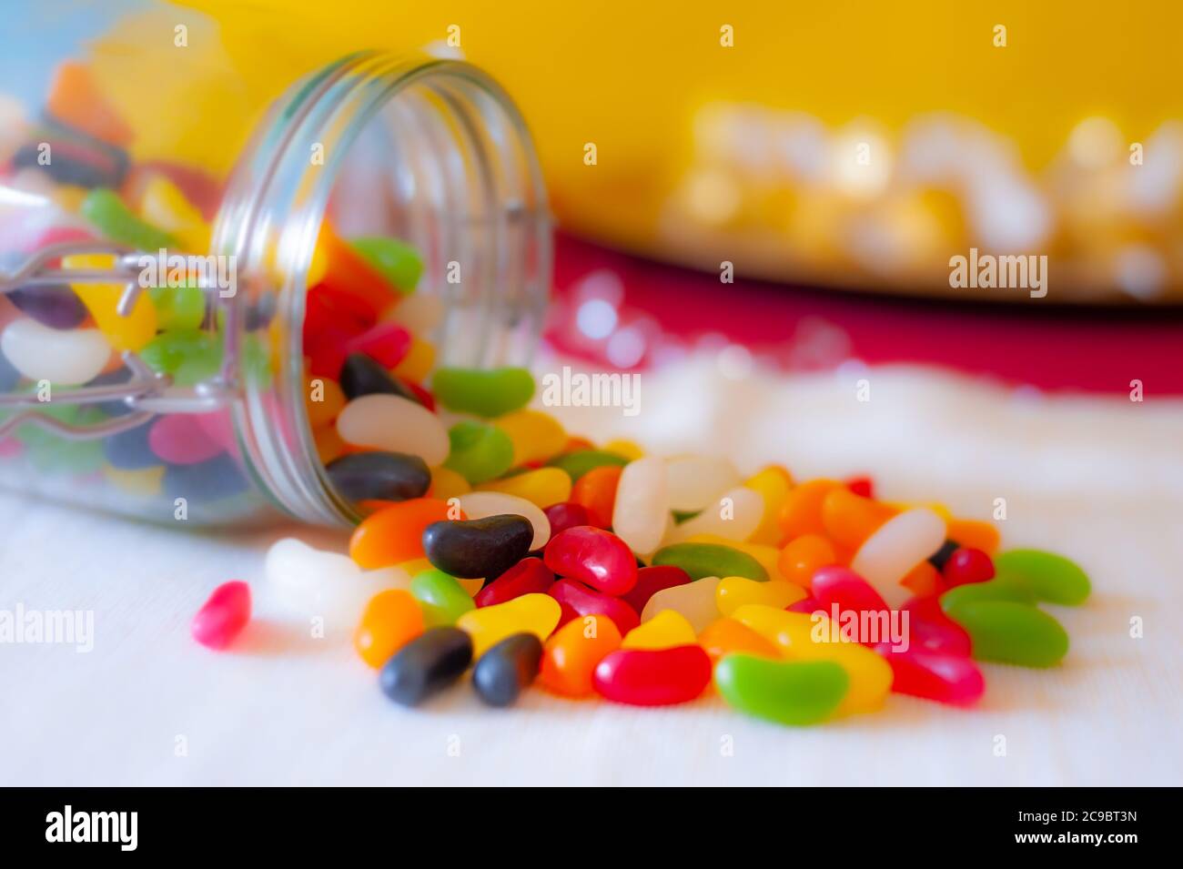 Jar full of colourful jelly beans sweets Stock Photo - Alamy