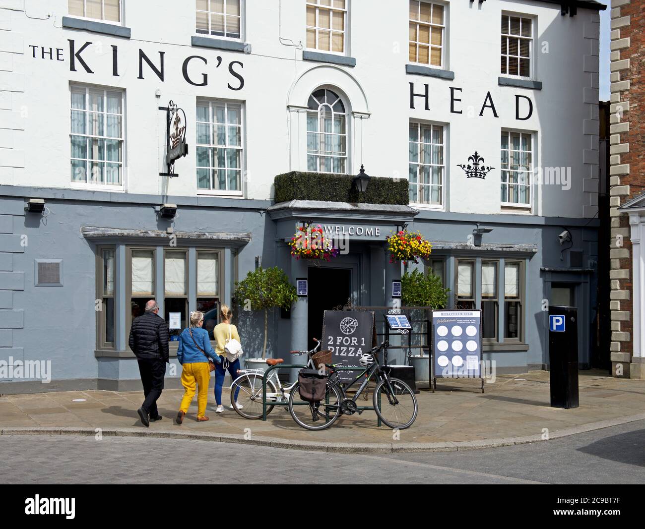 Family entering the King's Head pub and hotel, Saturday Martket ...