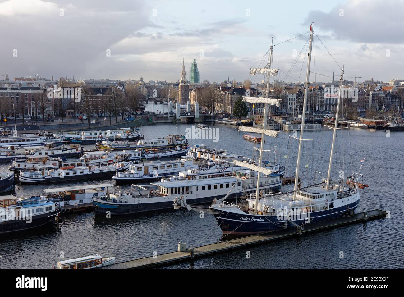 Cityscape of Amsterdam, Netherlands with historic ships in the harbour ...
