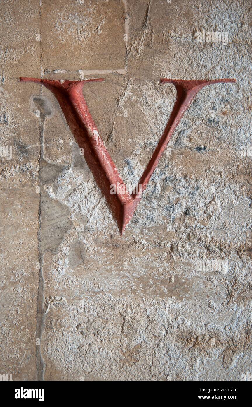 The Letter V Carved Into An Old Stone Wall And Highlighted In Red Paint ...