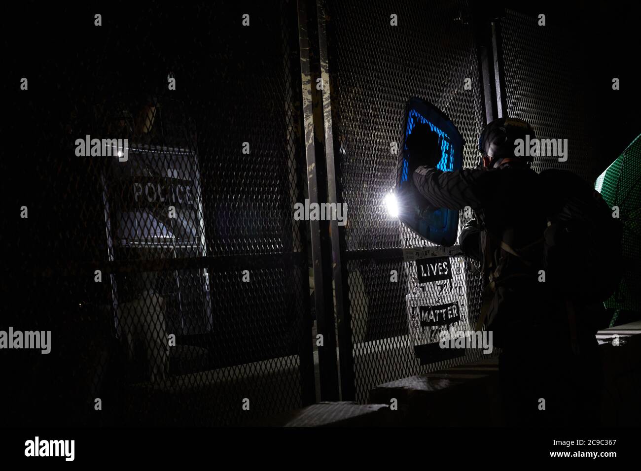 Portland, Oregon, U.S.A. 29th July, 2020. Protestors bang on the fence ...