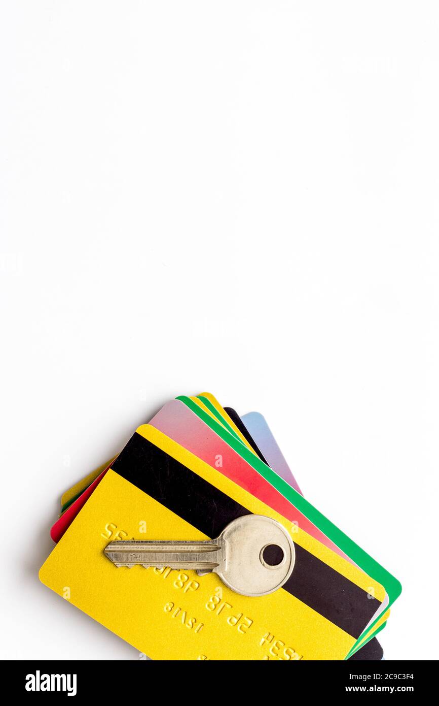 Credit card security concept with key on white desk top-down copy space ...
