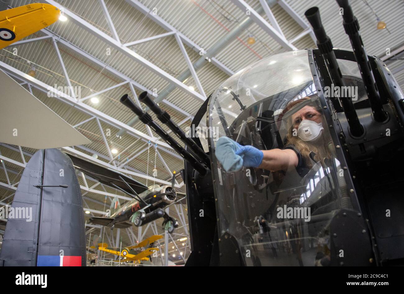 Preventive conservator Samantha Archetti cleans the rear gun turret of ...