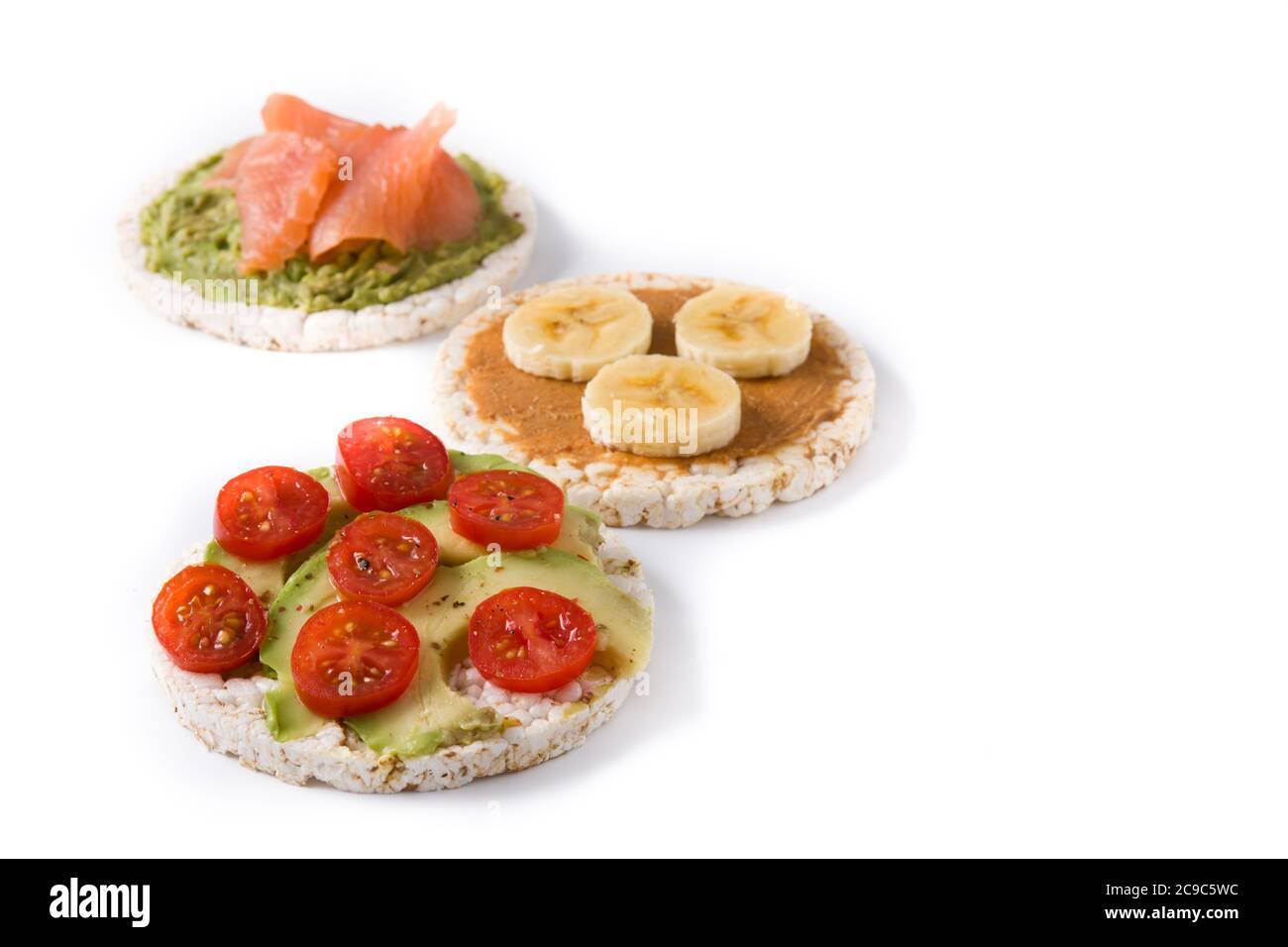 Assortment of ingredients on puffed rice cakes isolated on white ...