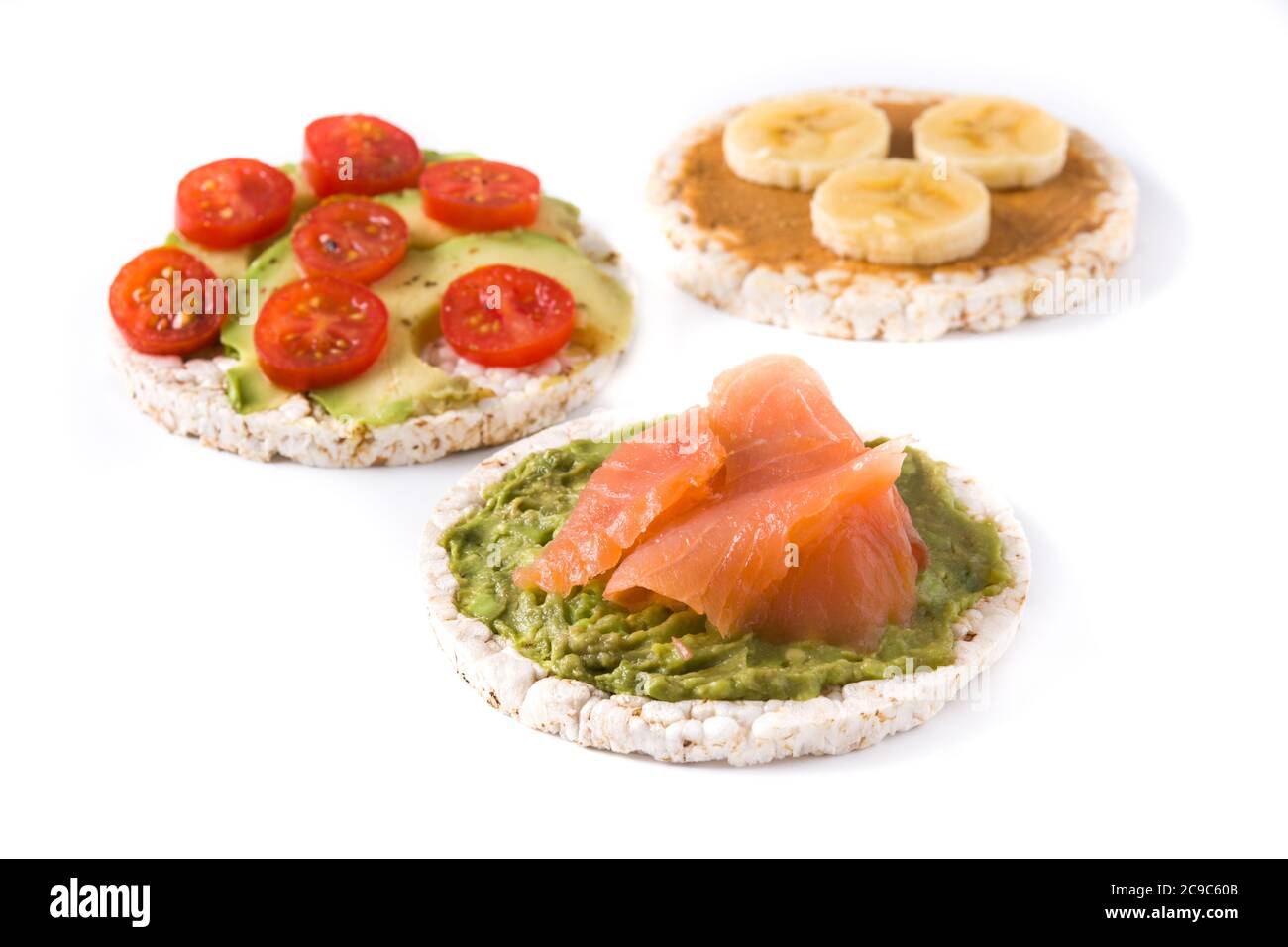 Assortment of ingredients on puffed rice cakes isolated on white ...