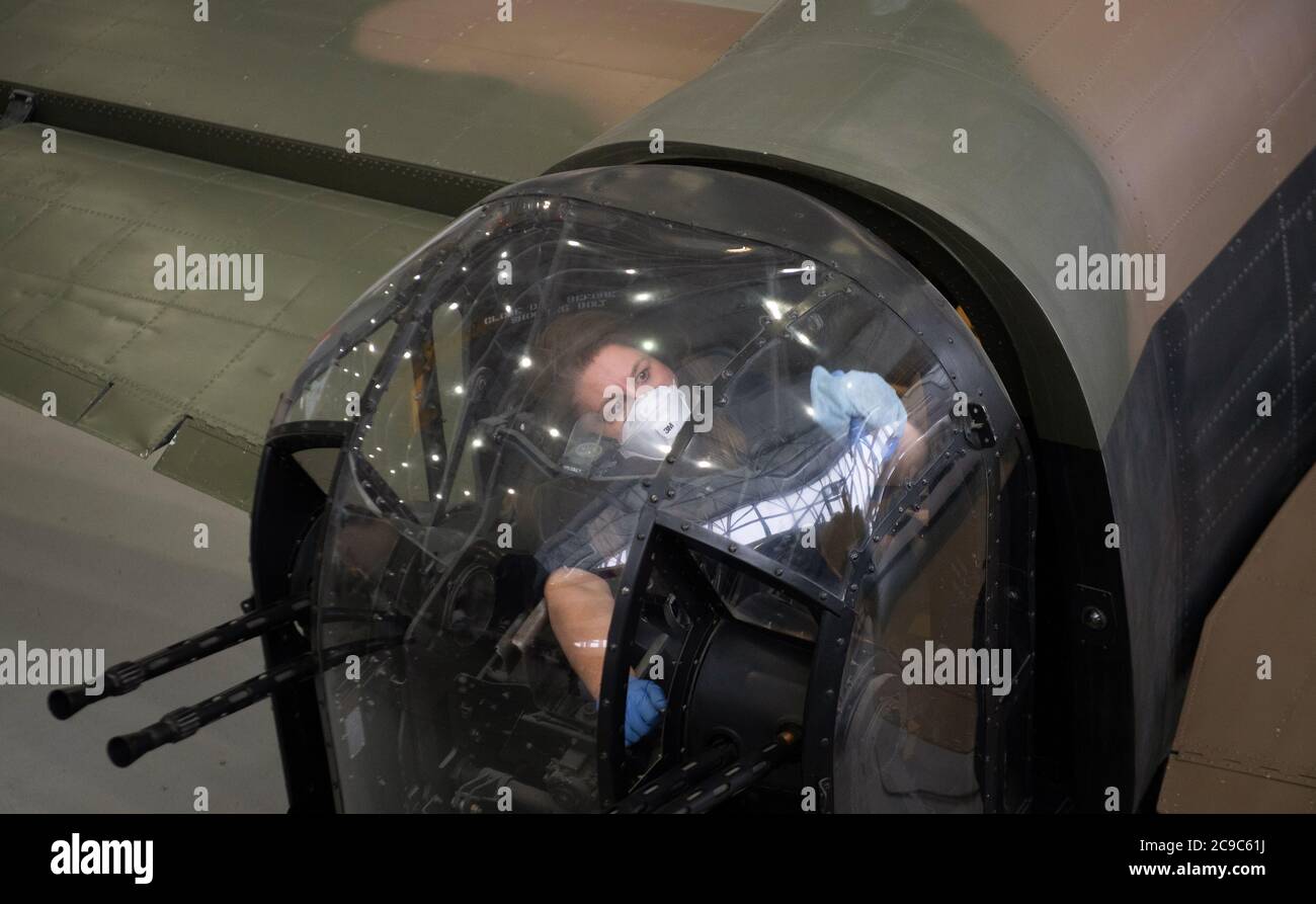 Preventive conservator Samantha Archetti cleans the rear gun turret of ...