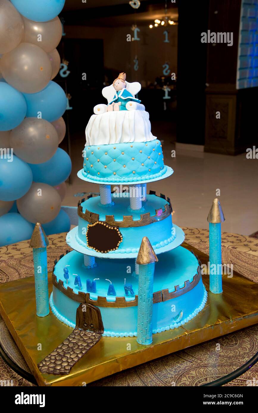 blue castle birthday cake with doll for children party, selective focus ...