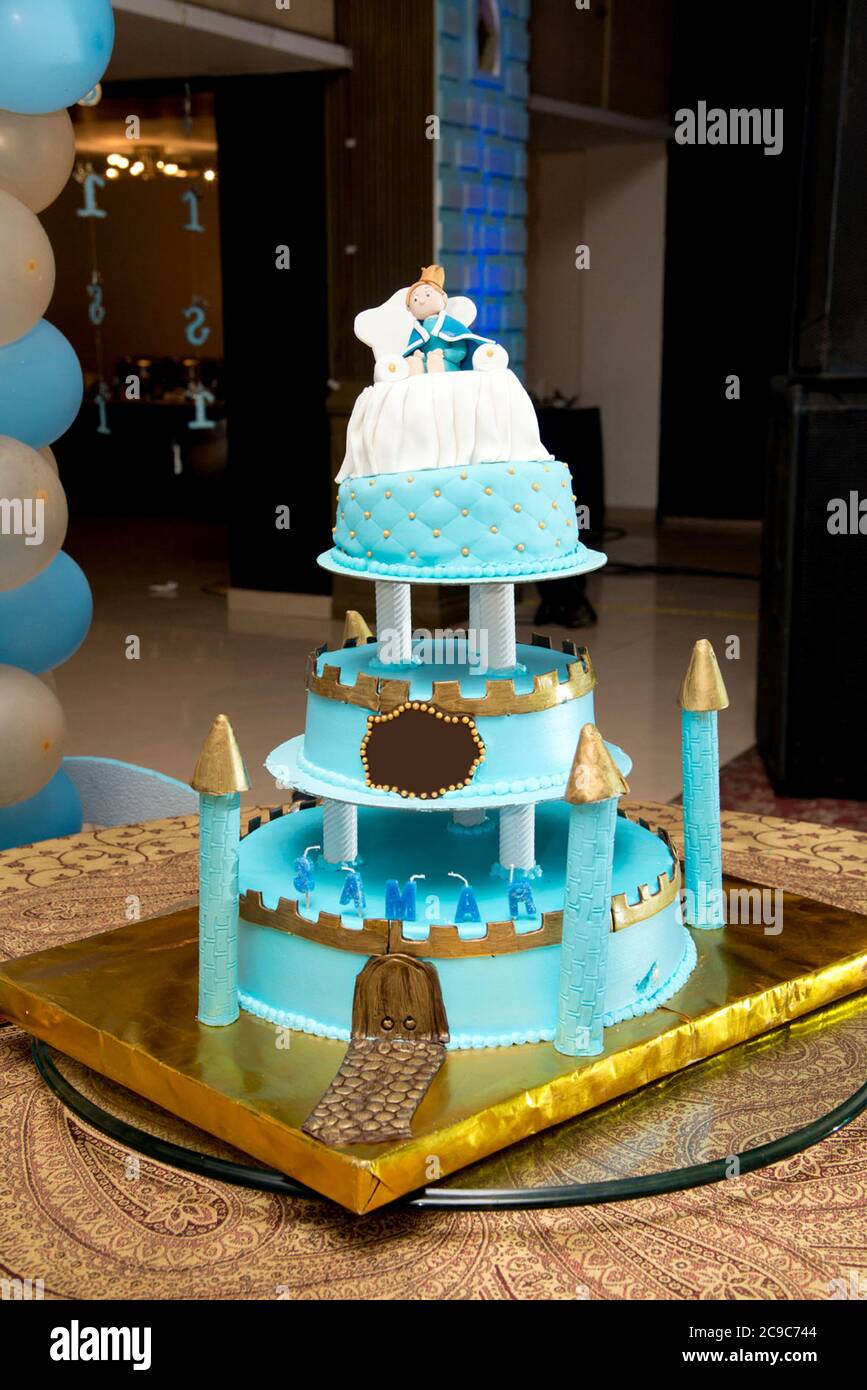blue castle birthday cake with doll for children party, selective focus ...