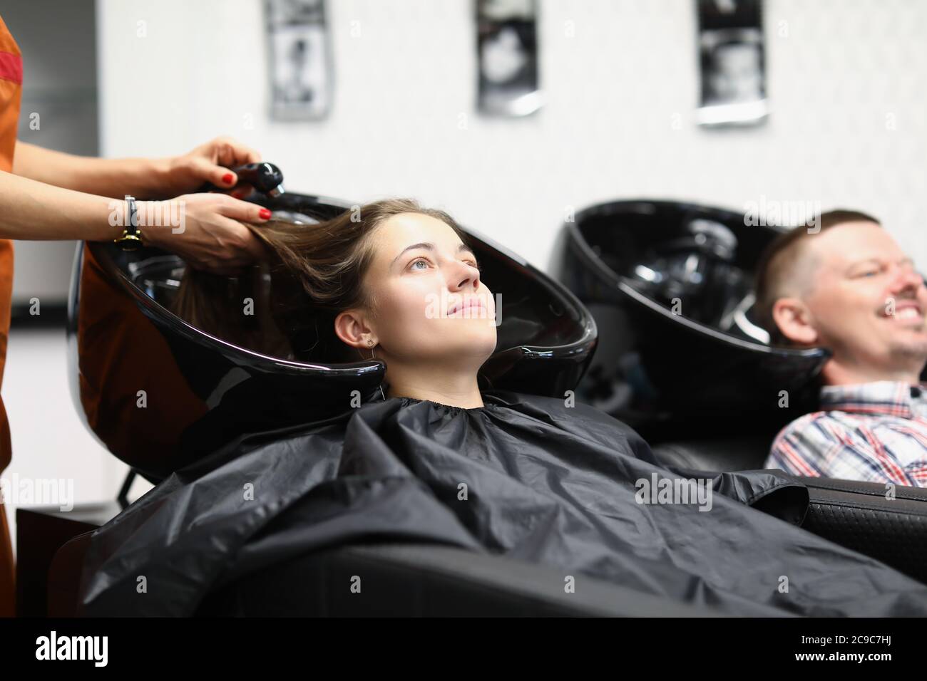A salon employee washes hair to woman in the sink Stock Photo - Alamy