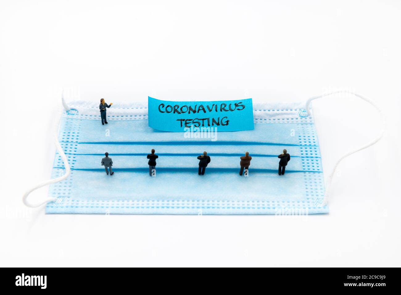 Miniature figurines posed as business people standing socially ...