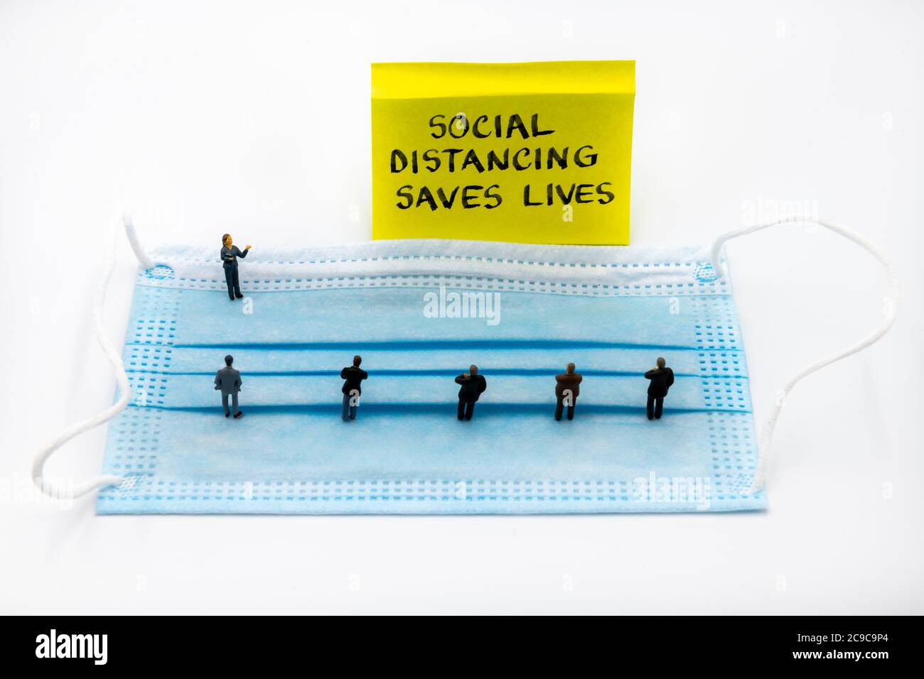 Miniature figurines posed as business people standing socially ...