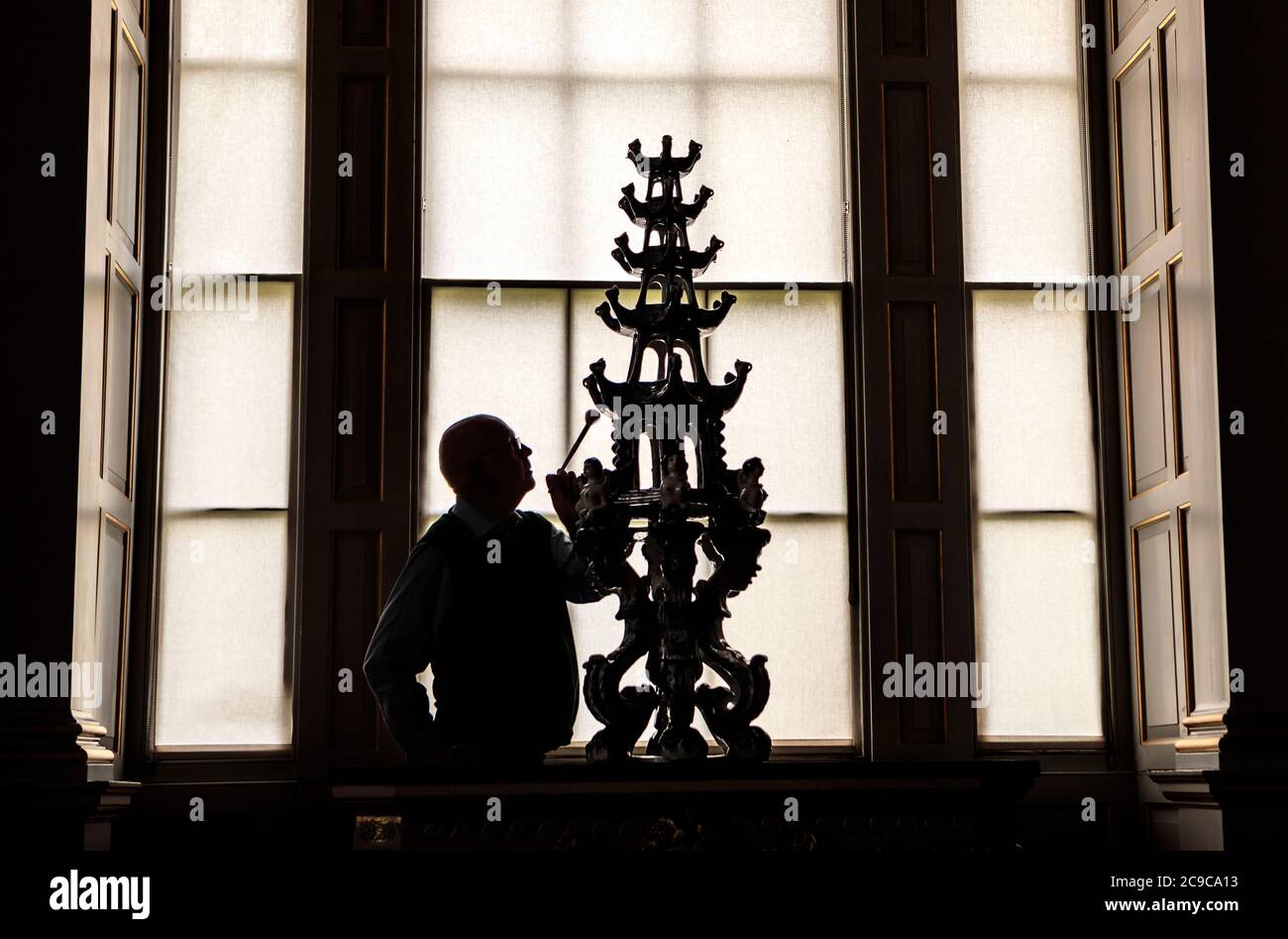 Castle Howard employee Dr Chris Ridgway cleans an ornate 17th-century ...