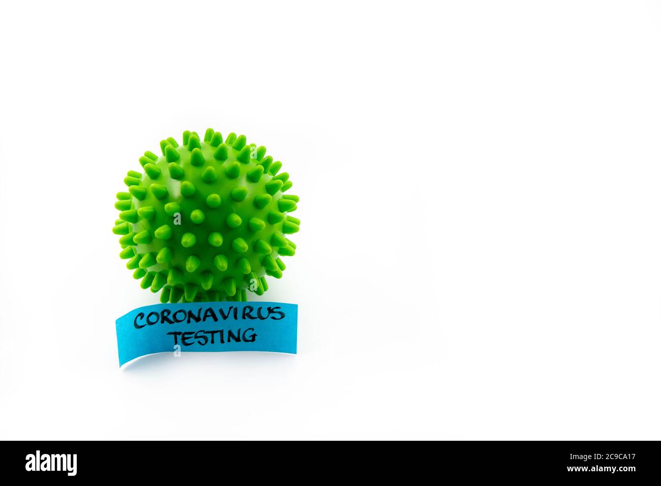 Closeup on green spiky ball as coronavirus representation and post-it ...