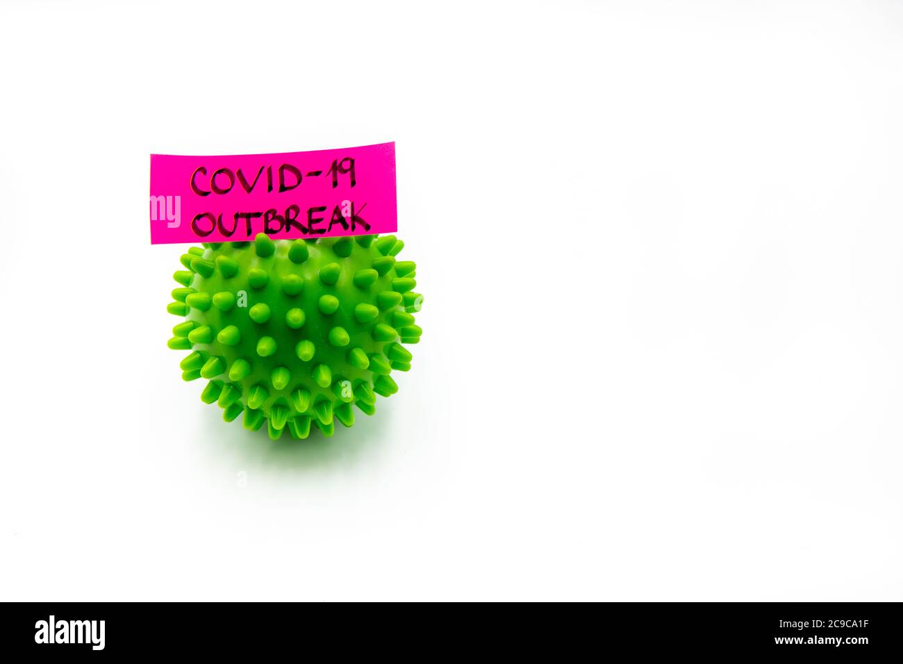 Closeup on green spiky ball as coronavirus representation and post-it ...