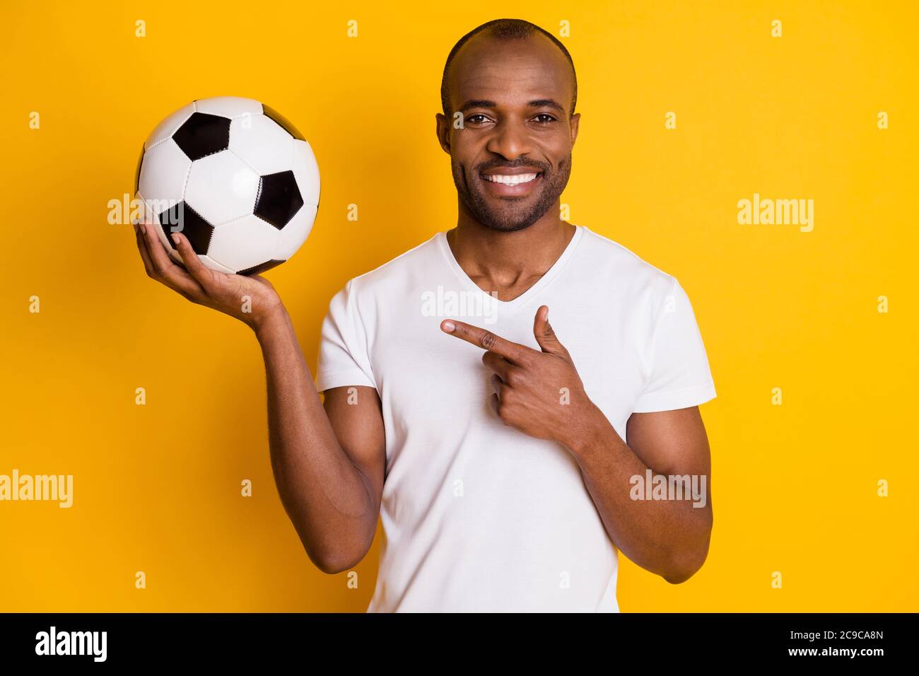 Portrait of positive cheerful afro american guy coach teach kids play ...