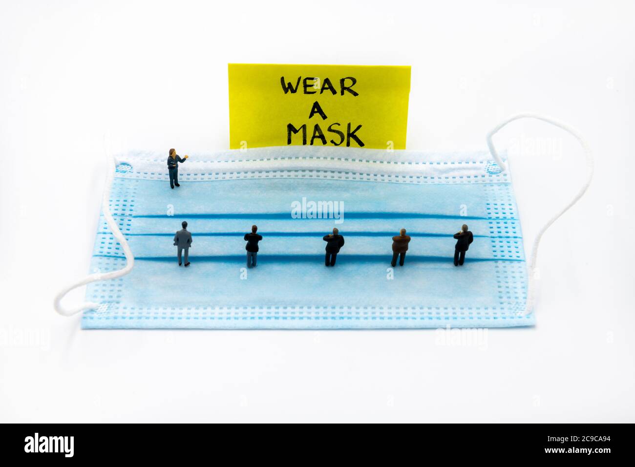 Miniature figurines posed as business people standing socially ...