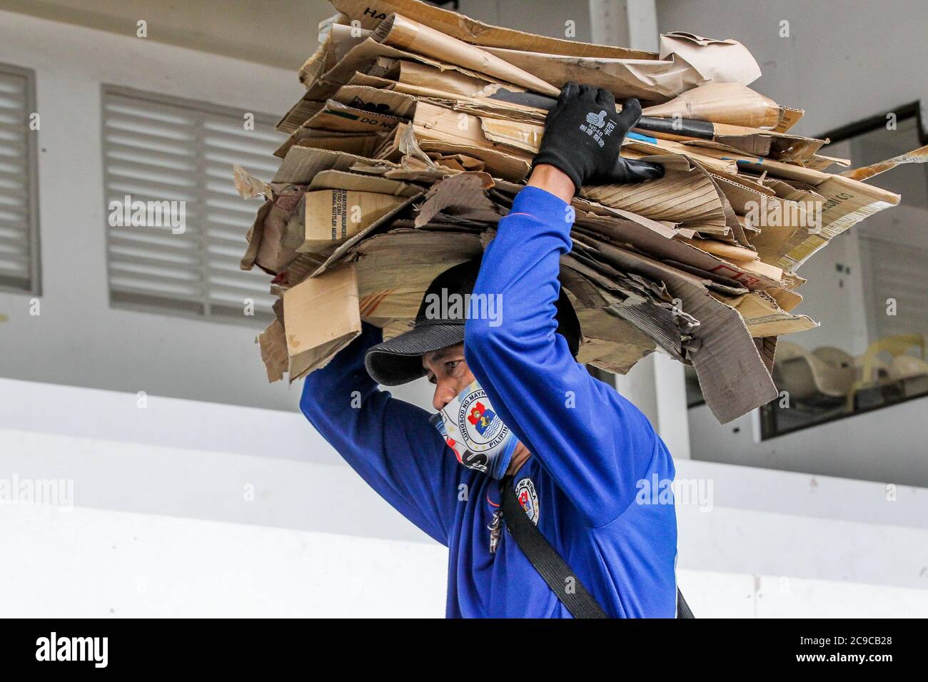 Manila, Philippines. 30th July, 2020. A staff member carries garbage at ...