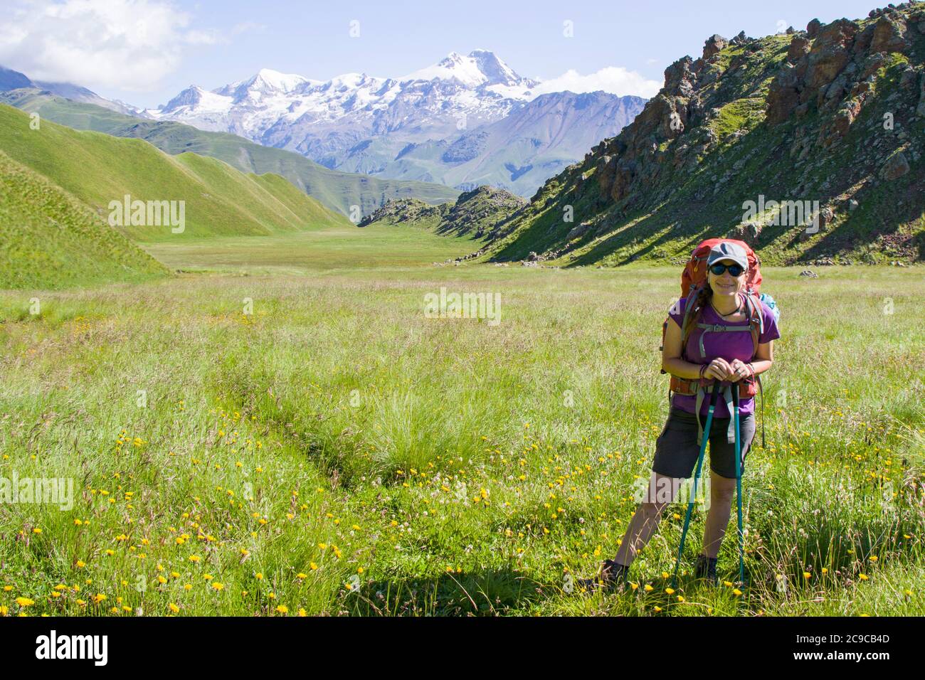 Hiker on the mountain landscape background, young girl backpacker in ...