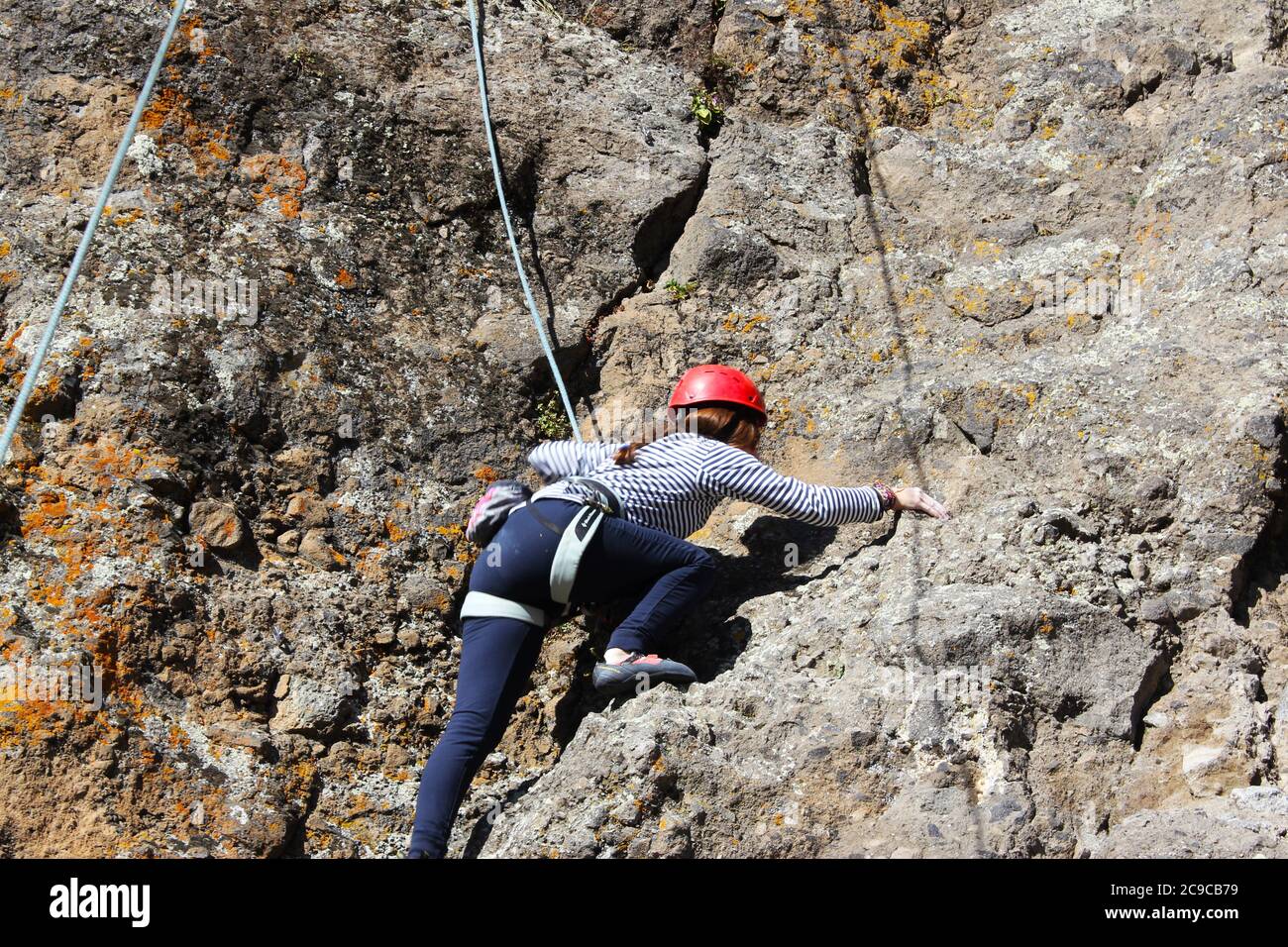 Climbers on the cliff edge, climbing scene. Young beautiful woman ...
