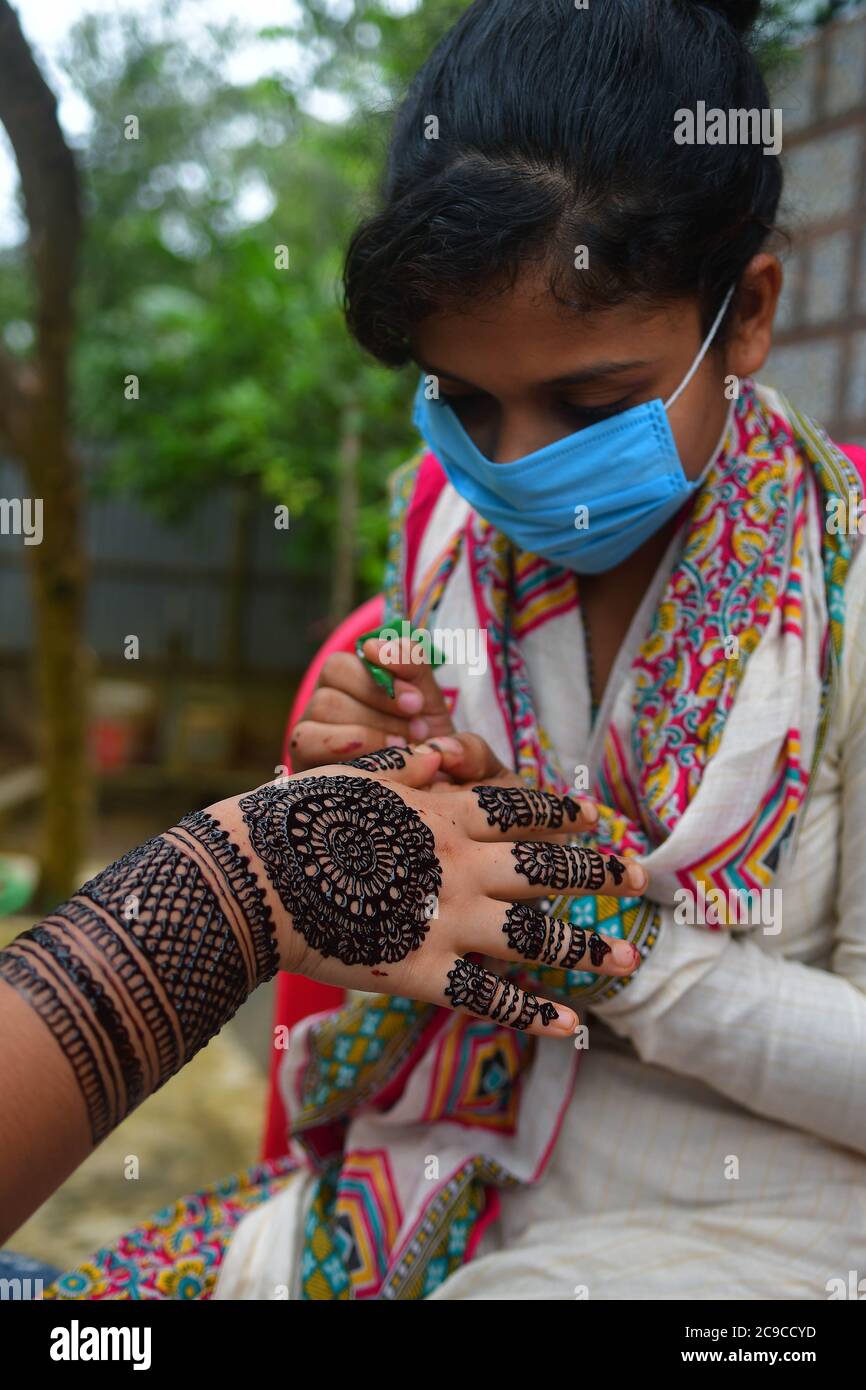 A Muslim girl painting traditional henna designs, ahead of the Muslim ...