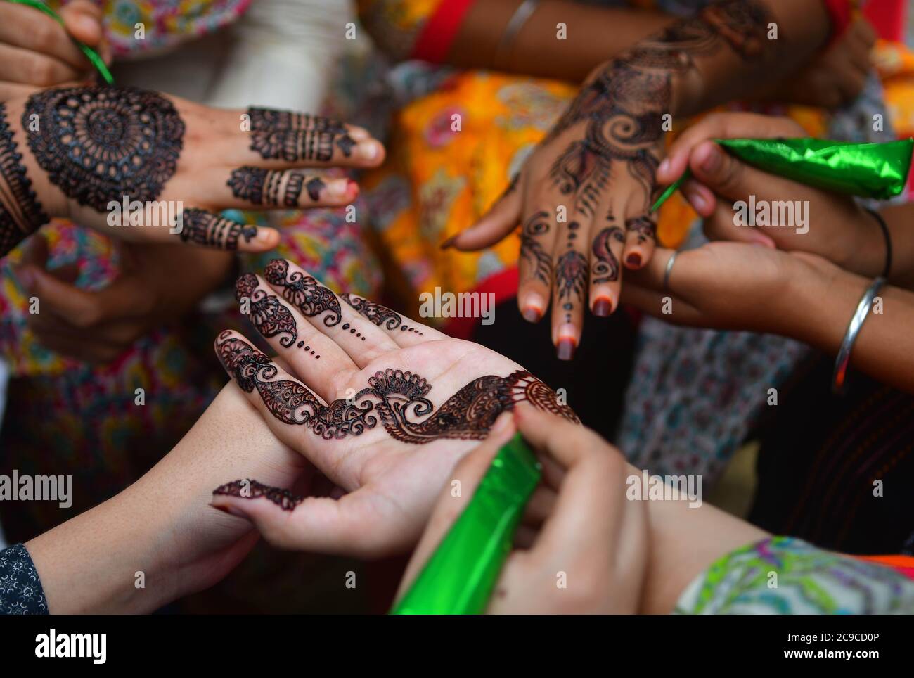 Muslim girls showing thier hands which are painted with traditional ...