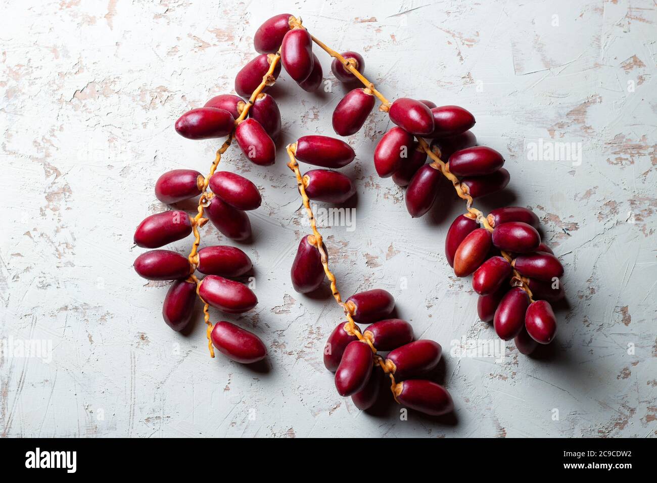 fresh red dates fruits on texture white background Stock Photo - Alamy