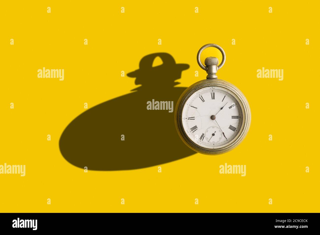 Old pocket clock with a bold shadow in a yellow background Stock Photo ...