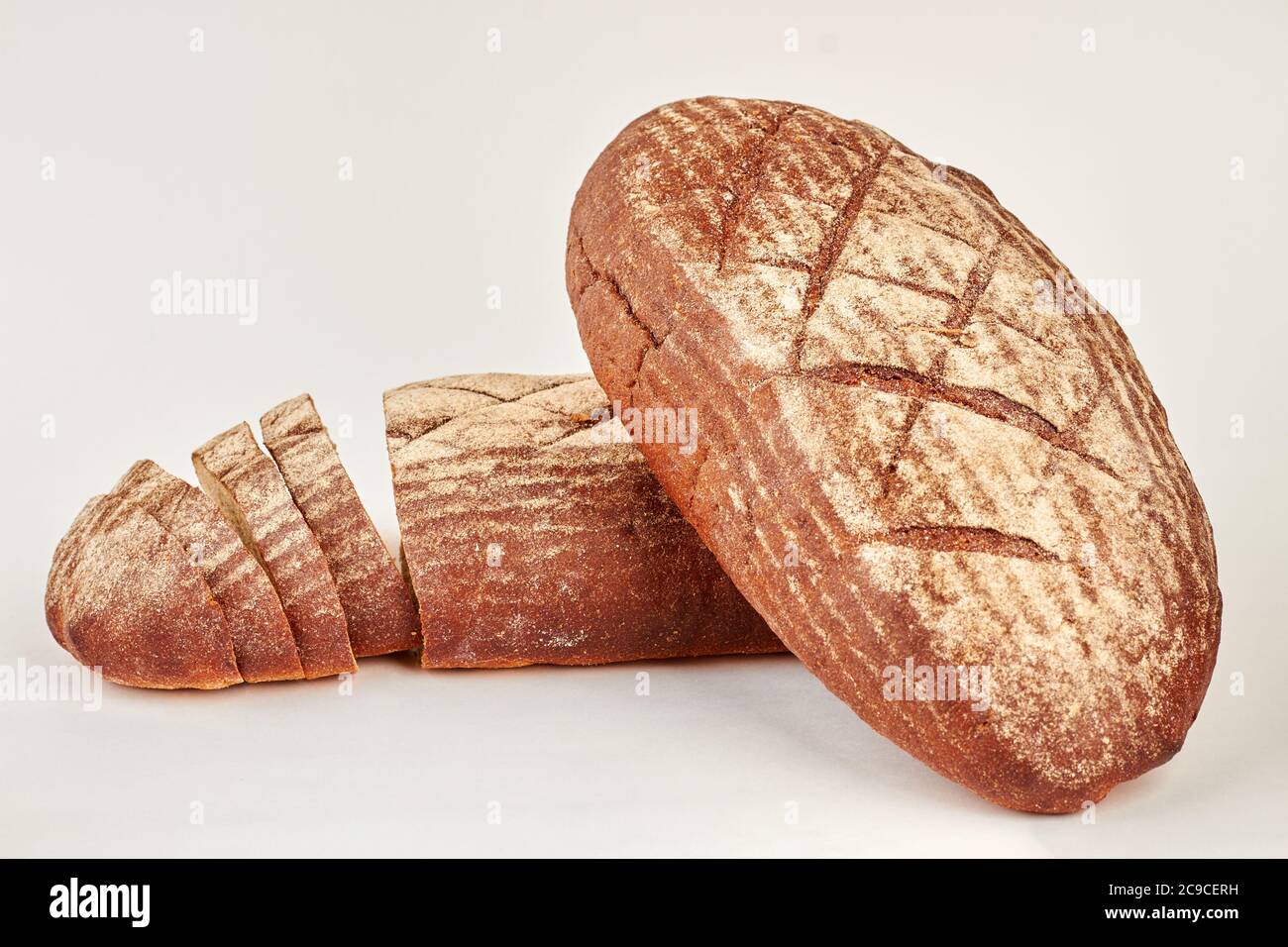 Two loaves of dark bread on white background Stock Photo - Alamy