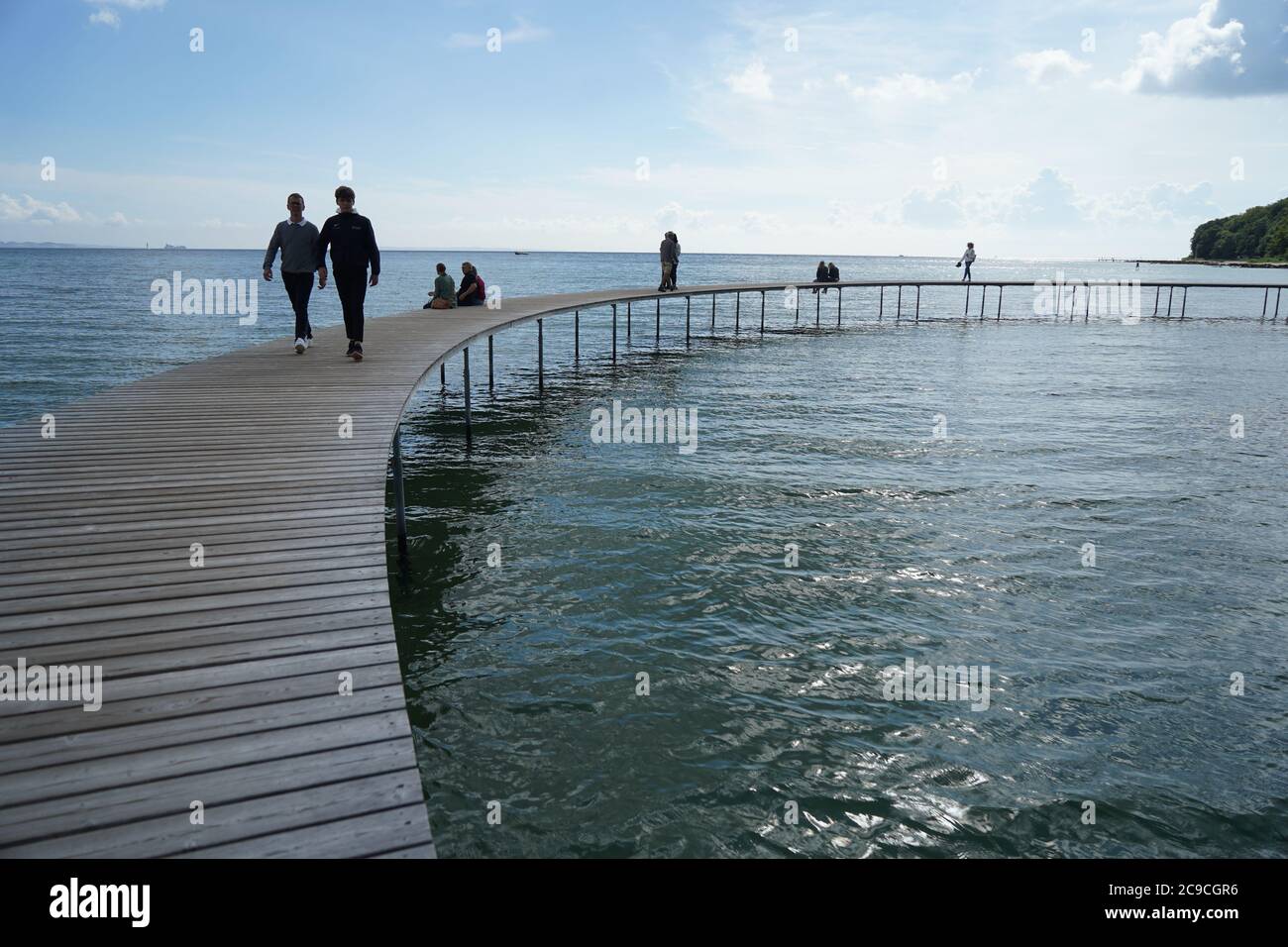 Aarhus, Denmark. 27th July, 2020. People walk across The Infinite Bridge. The bridge is a ...