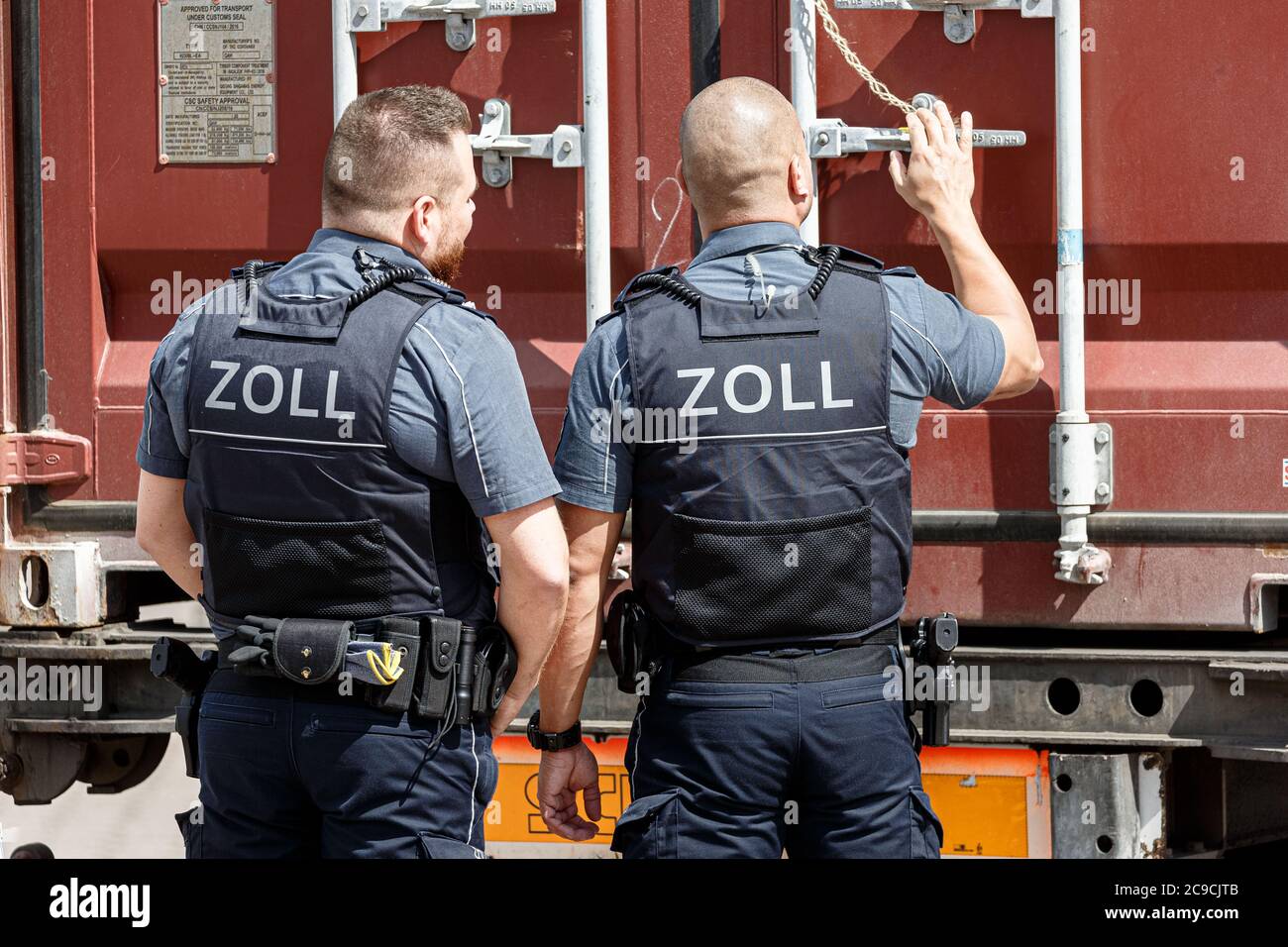 Hamburg, Germany. 30th July, 2020. Two customs officials check the customs seal on a container ...