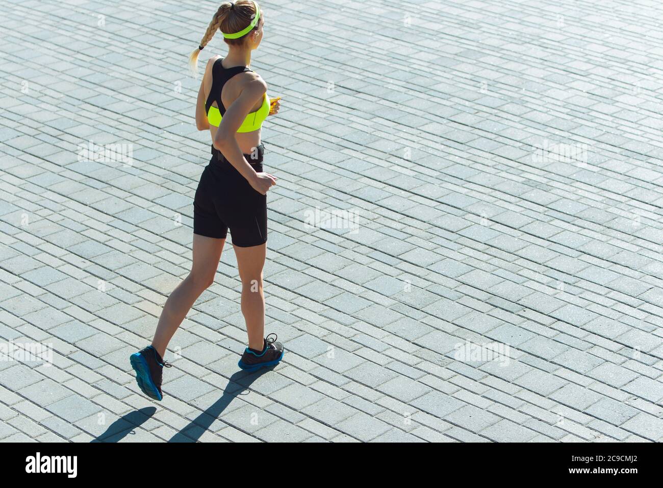 Female runner, athlete training outdoors in summer's sunny day ...