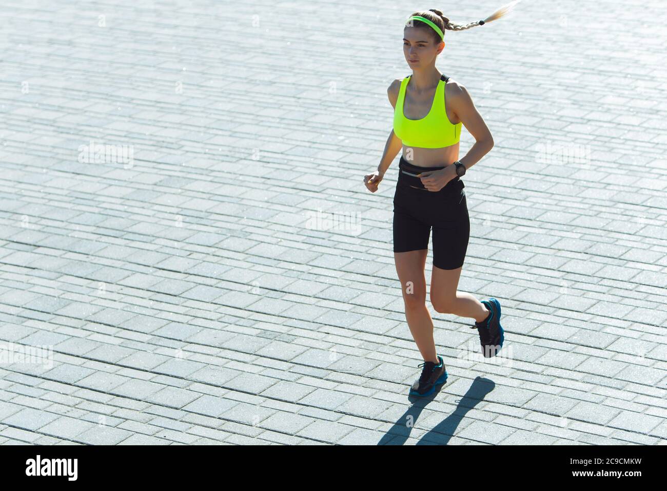 Female runner, athlete training outdoors in summer's sunny day ...
