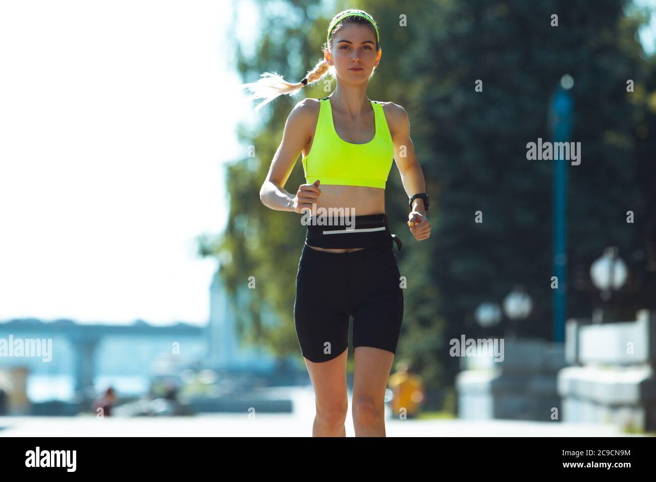 Purposeful. Female runner, athlete training outdoors. Professional ...