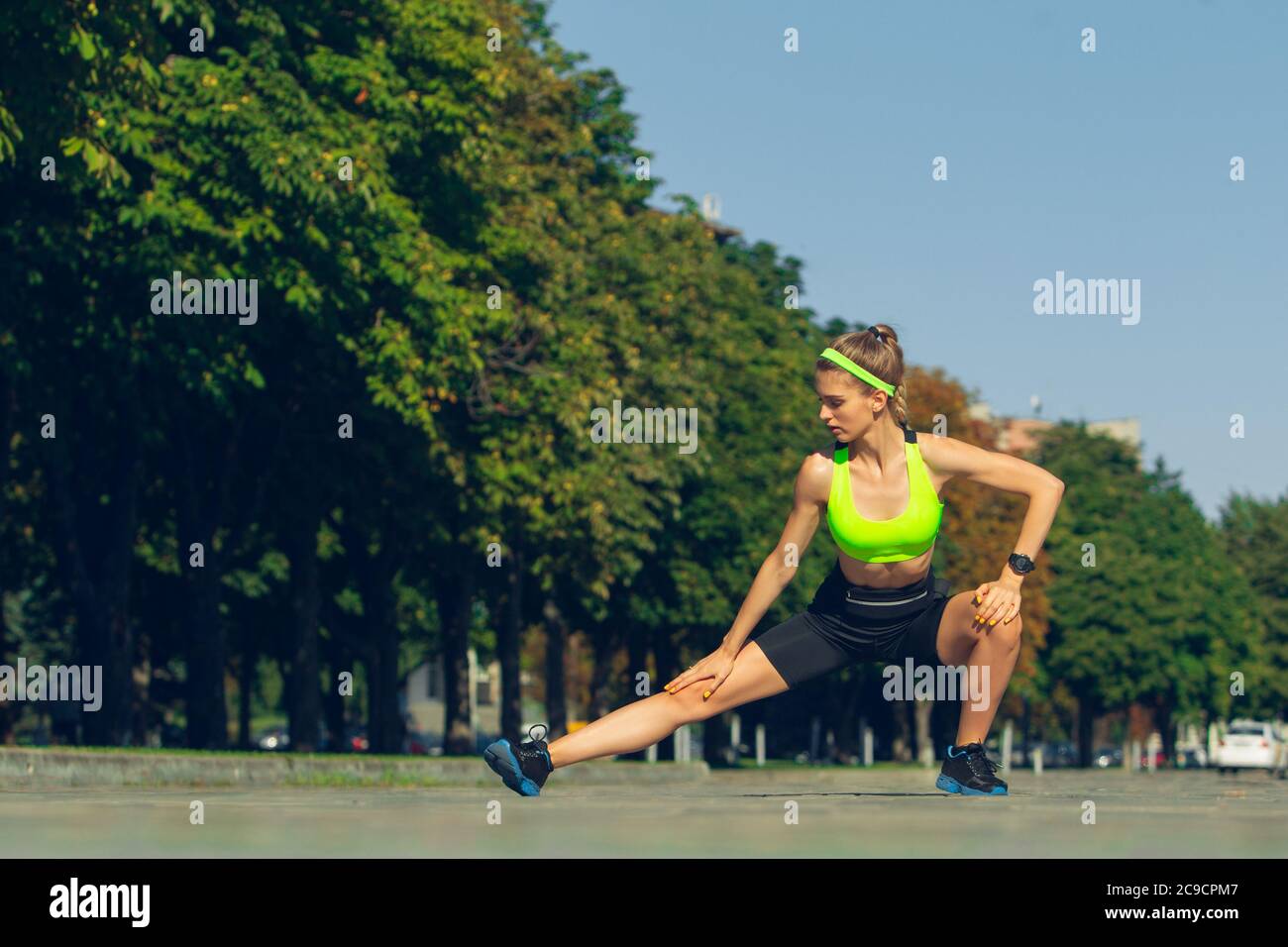 Stretching. Female runner, athlete training outdoors. Professional ...