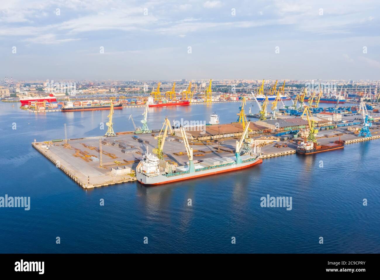 Aerial view huge cargo ship moored at the pier at the port, loading ...