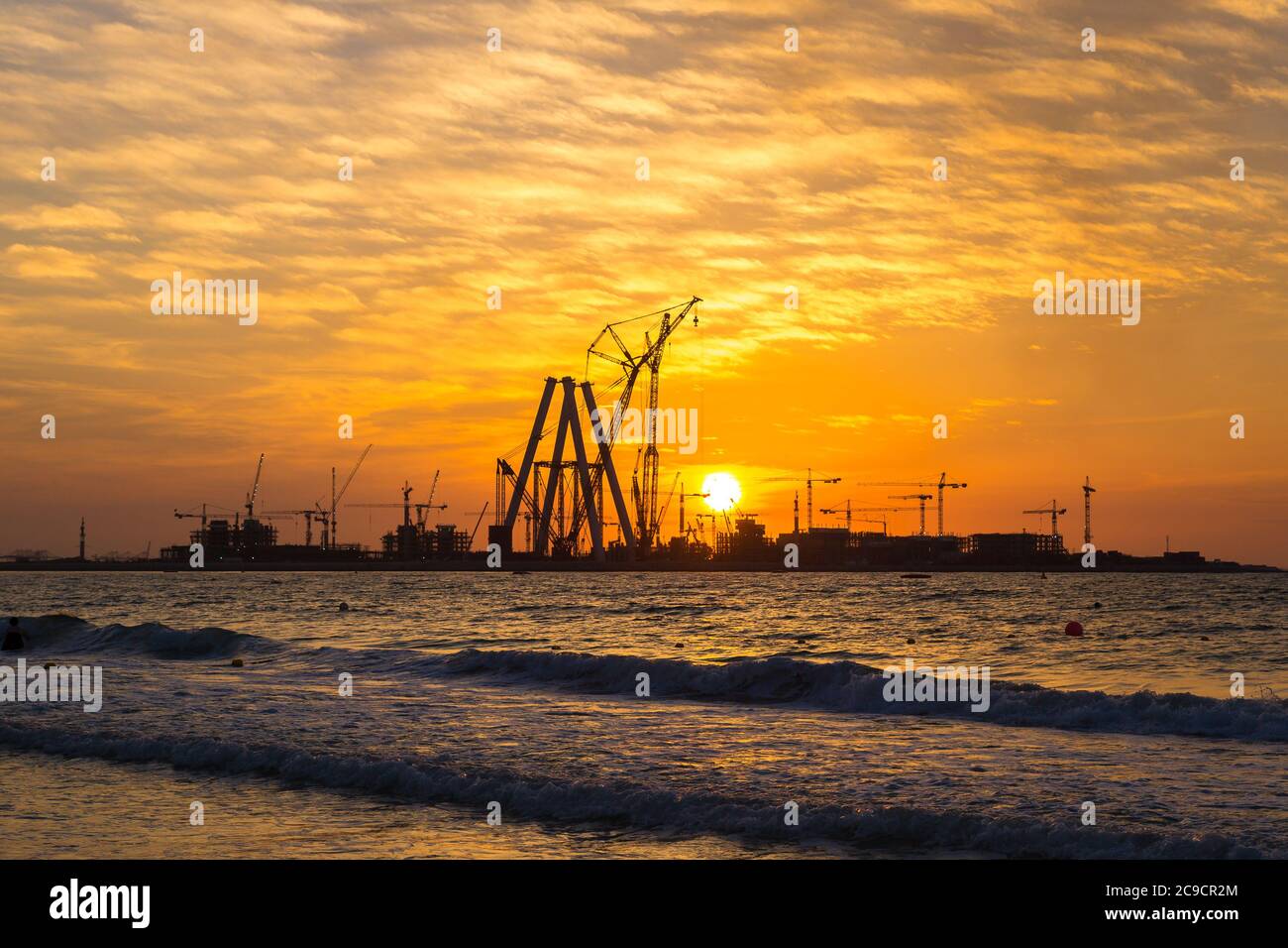 Construction site in Dubai at the sea sunset Stock Photo - Alamy