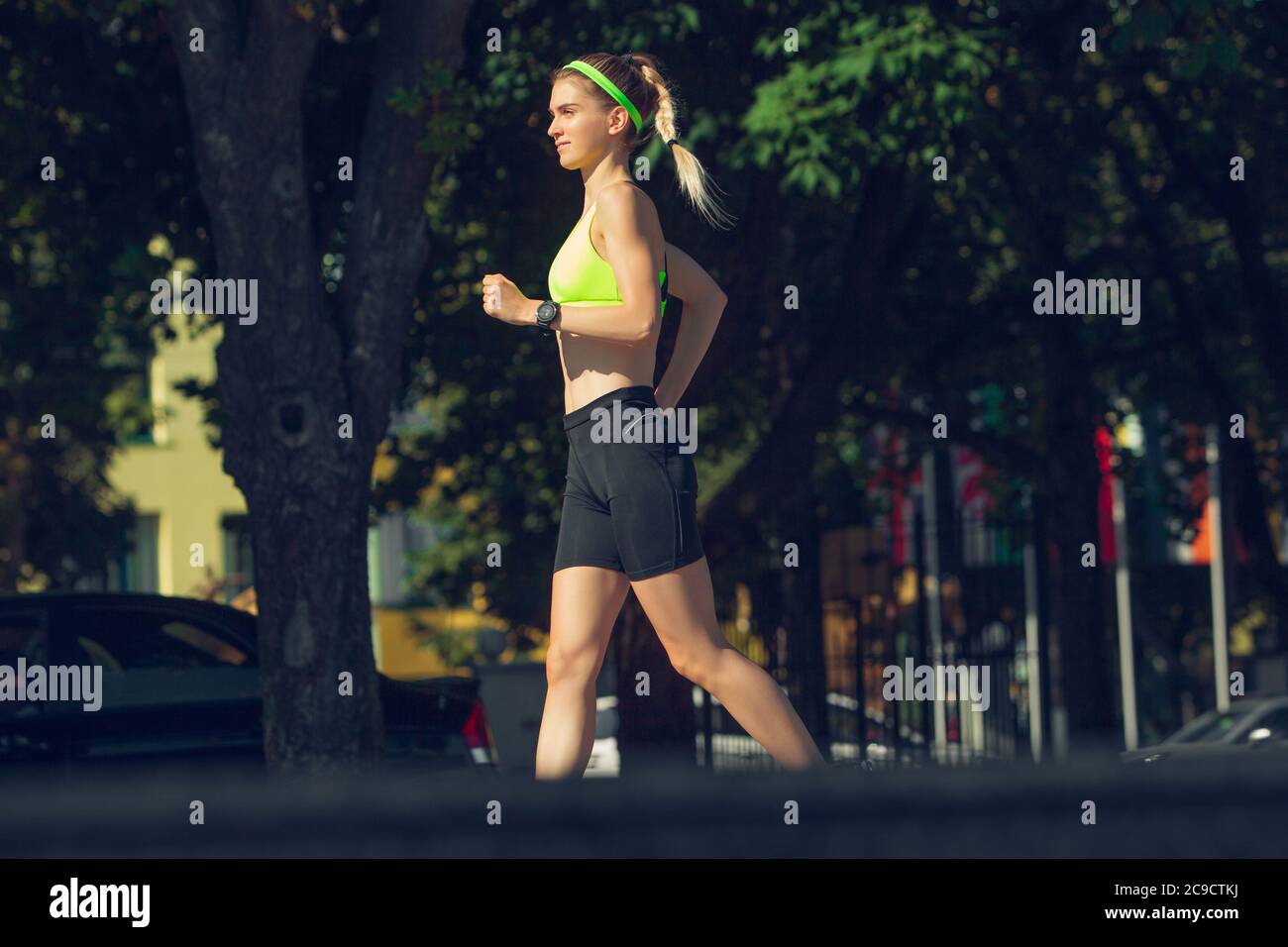 Motivation. Female runner, athlete training outdoors. Professional ...