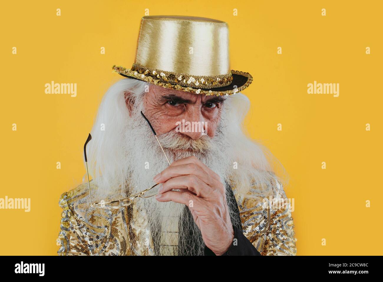 Fashionable grandfather posing with funny clothes. Senior man portraits ...