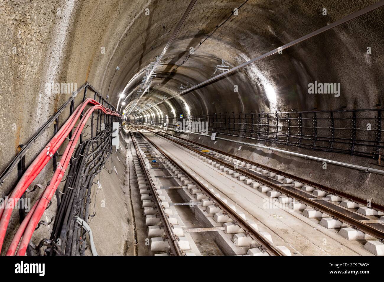 Subway tunnel rail tracks. Red tubes with electric cables Stock Photo ...