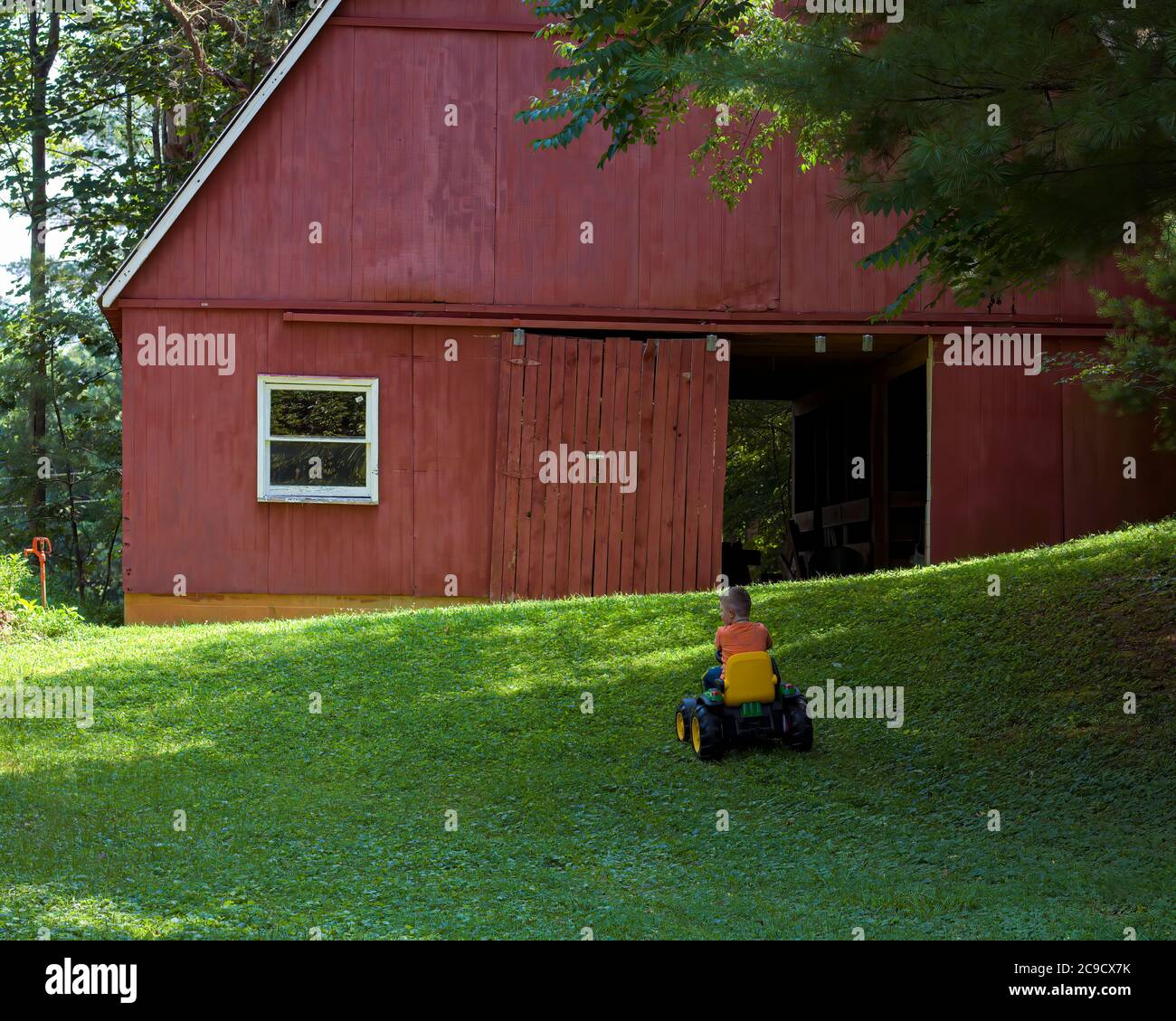 Boy driving tractor hi-res stock photography and images - Alamy