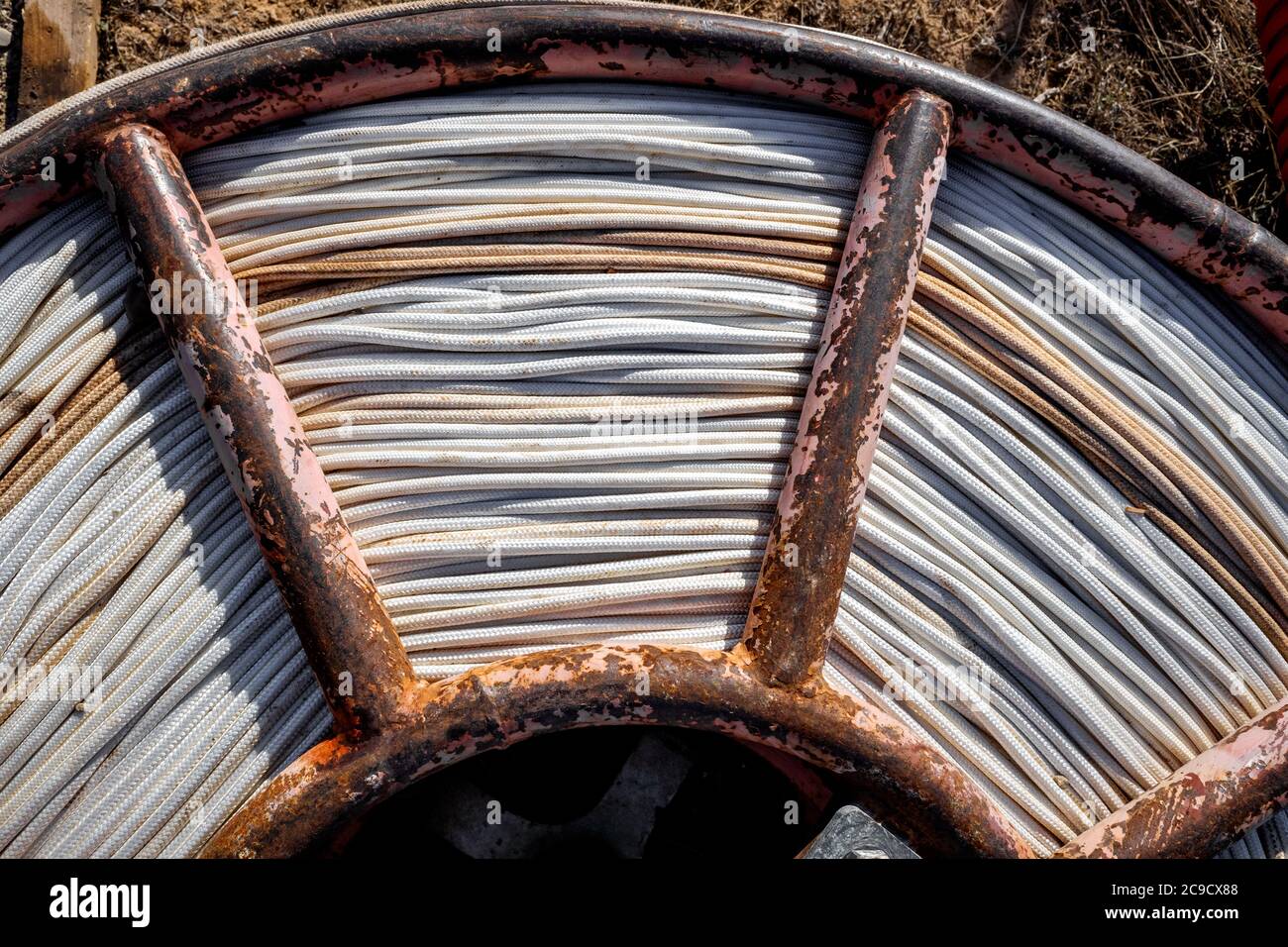 Rusty coil of white rope for construction Stock Photo - Alamy