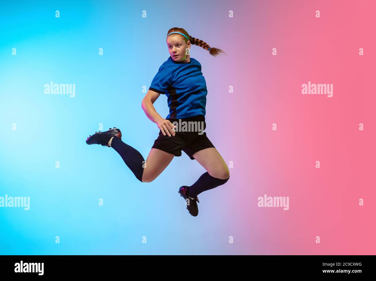High jumping. Female soccer, football player training in action ...