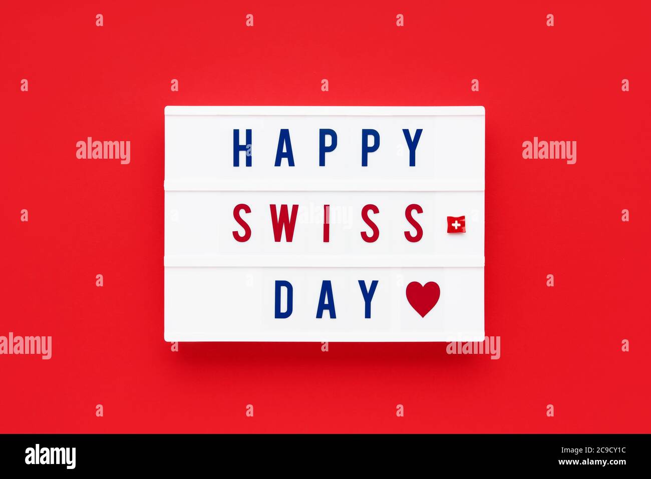 HAPPY SWISS DAY written in a lightbox on a red background. Independence ...