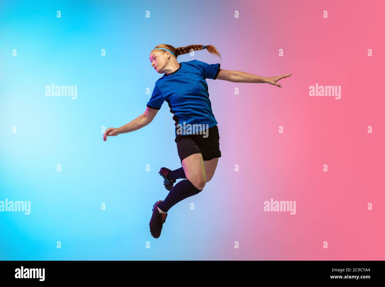 High jumping. Female soccer, football player training in action ...
