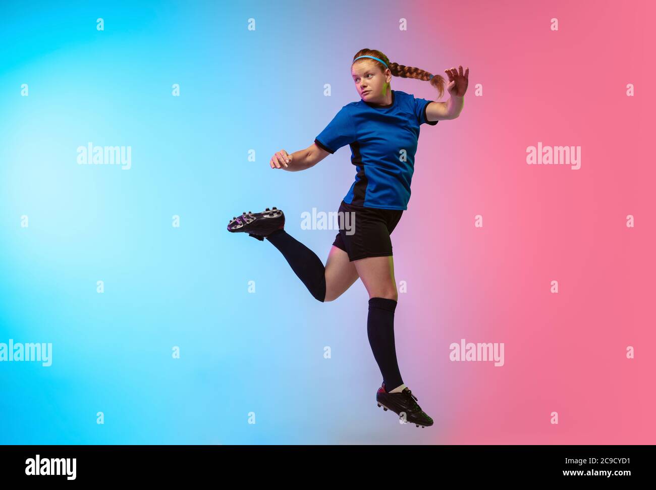 High jumping. Female soccer, football player training in action ...