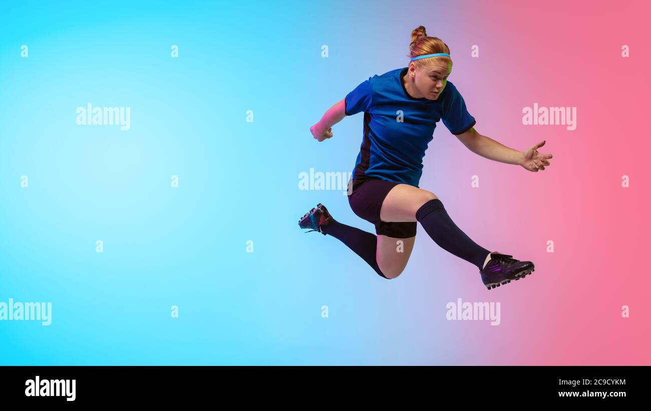 High jumping. Female soccer, football player training in action ...