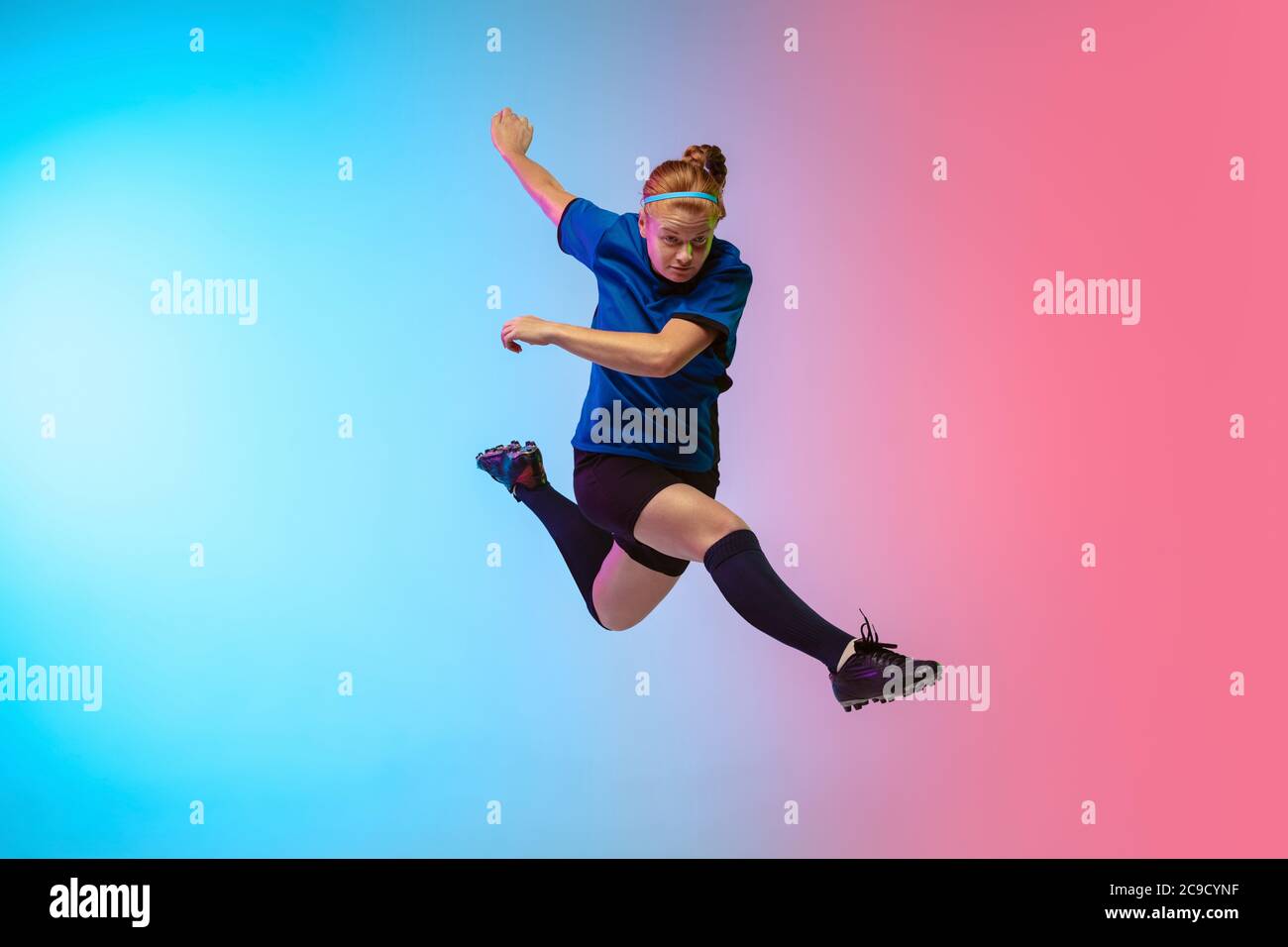 High jumping. Female soccer, football player training in action ...