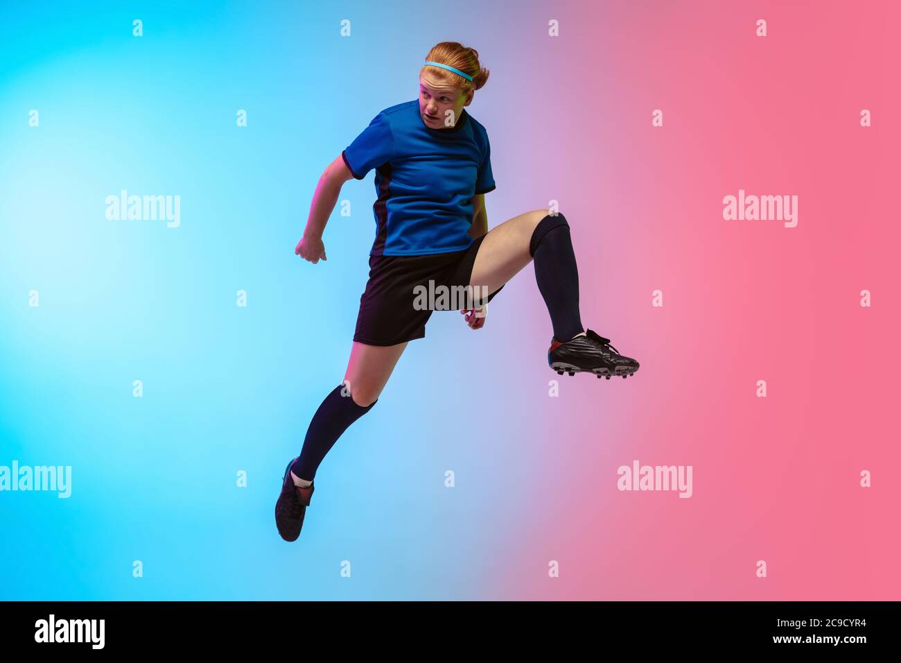 High jumping. Female soccer, football player training in action ...